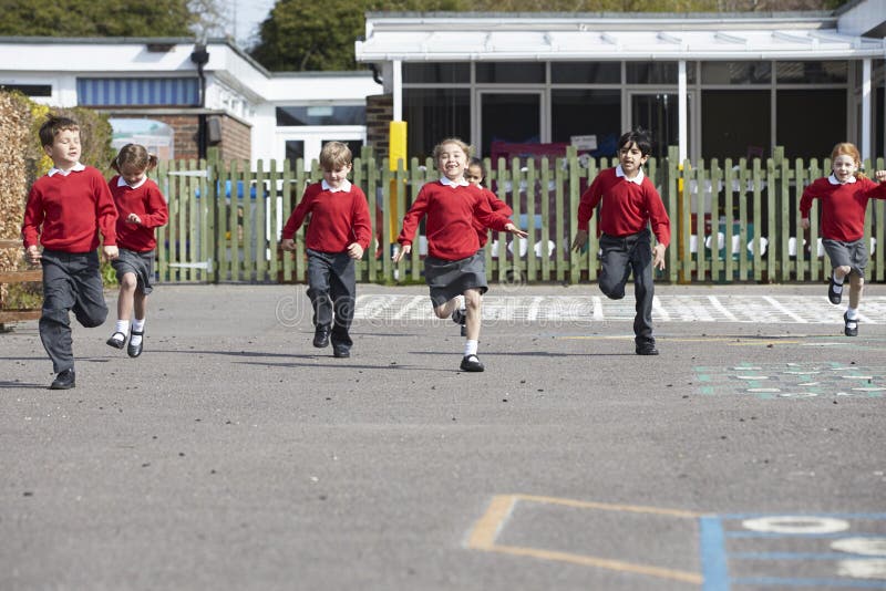 Elementary School Pupils Running in Playground Stock Photo - Image of ...