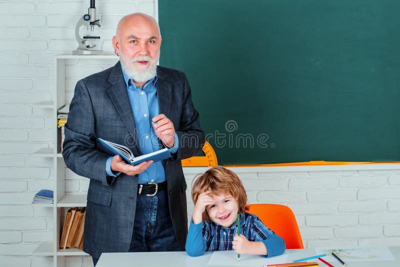 Professor and Pupil in Classroom at the Elementary School. Senior ...