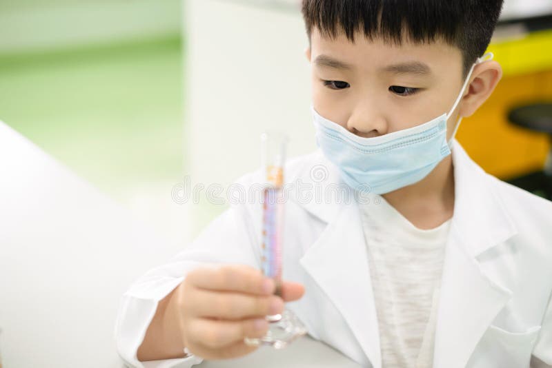 Elementary School Student Doing a Science Experiment. a Boy Looking at ...