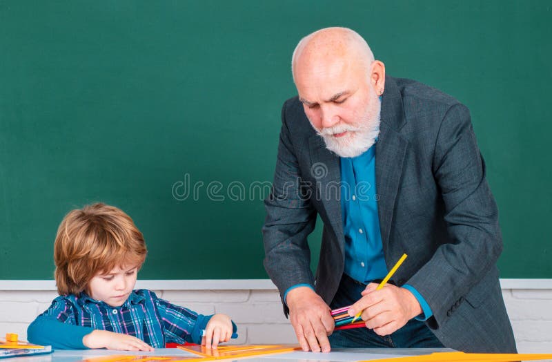 Elementary School Teacher Giving Female Pupil Support in Classroom ...