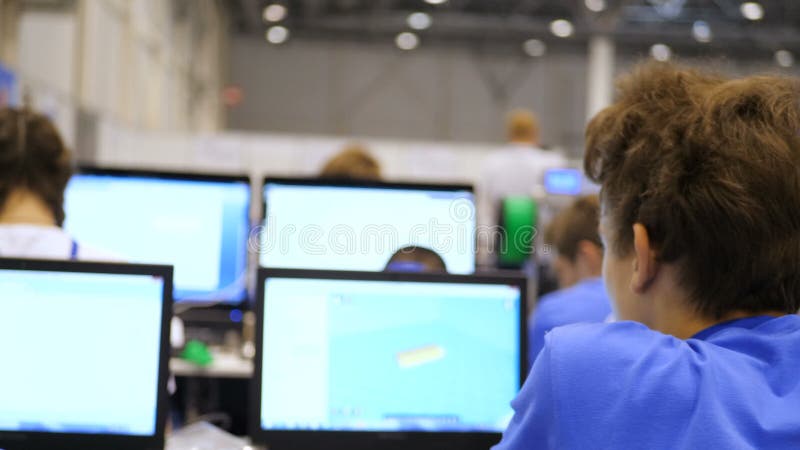 Elementary Teacher and His Students Using Laptop during Computer Class ...