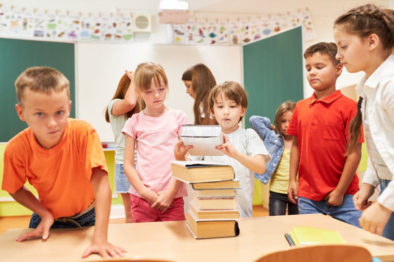 Students Stacking Books on Bench in Class Stock Image - Image of piling ...
