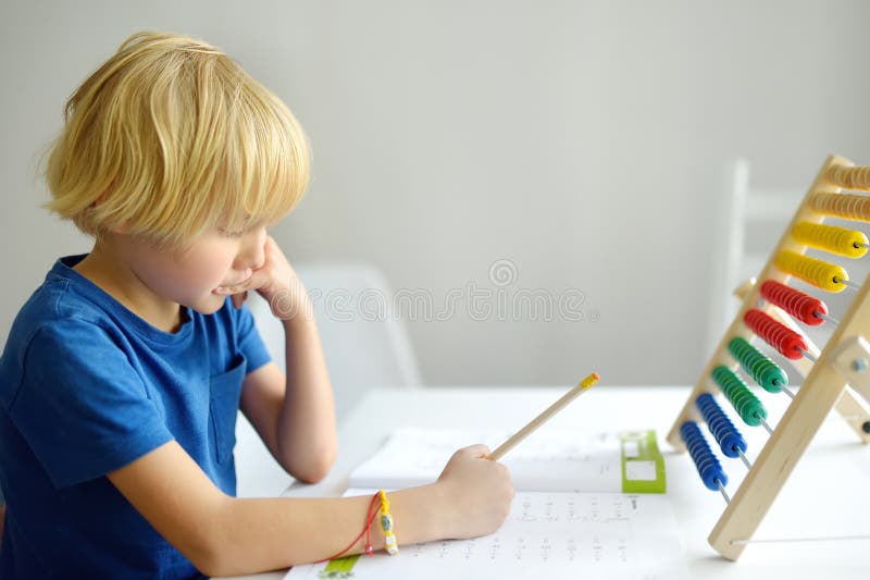 Elementary Student Boy Doing Homework at Home. Child Learning To Count ...