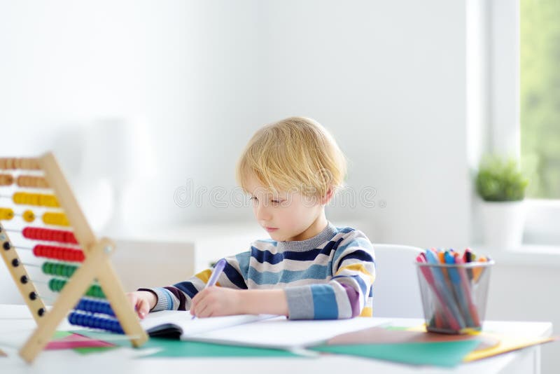 Elementary Student Boy Doing Homework at Home. Child Learning To Count ...