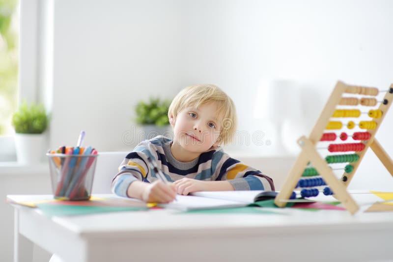 Elementary Student Boy Doing Homework at Home. Child Learning To Count ...