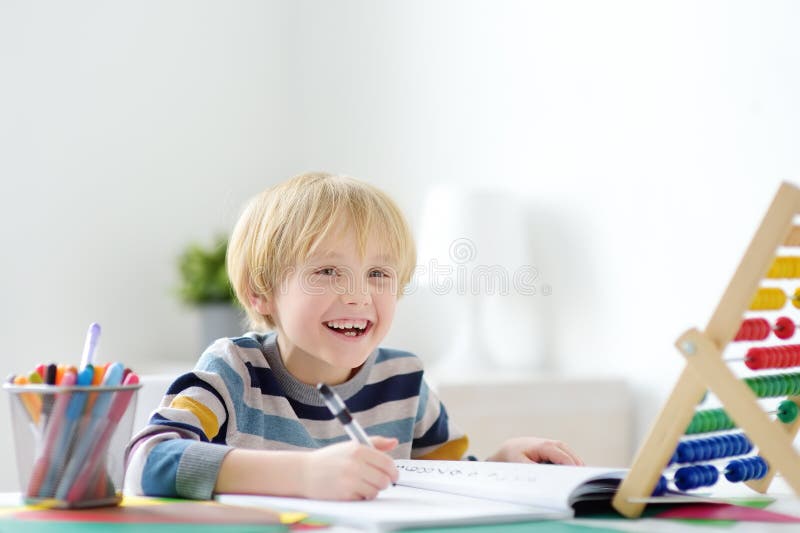 Elementary Student Boy Doing Homework at Home. Child Learning To Count ...