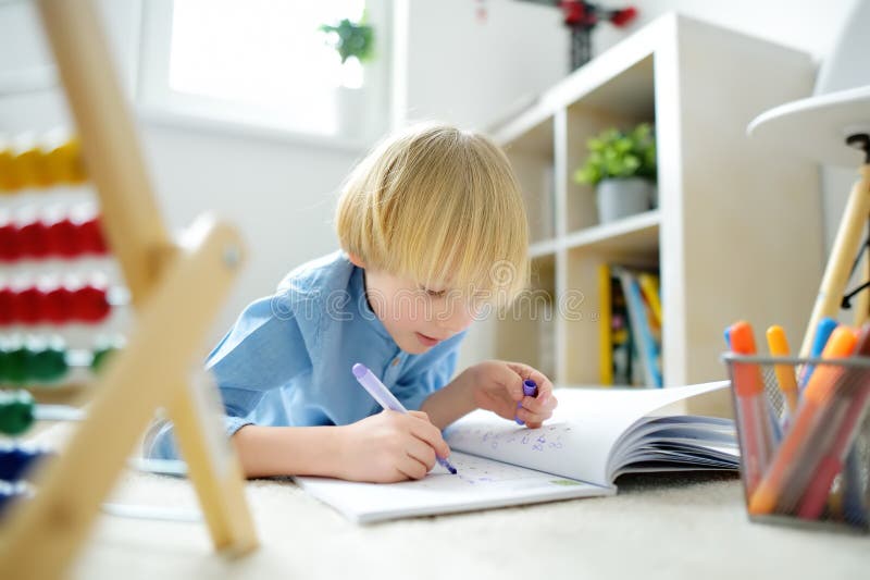 Elementary Student Boy Doing Homework at Home. Child Learning To Count ...