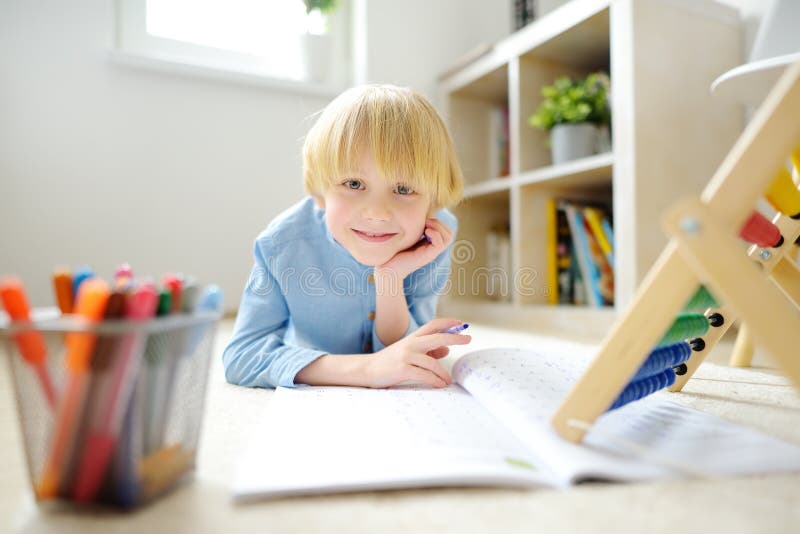 Elementary Student Boy Doing Homework at Home. Child Learning To Count ...