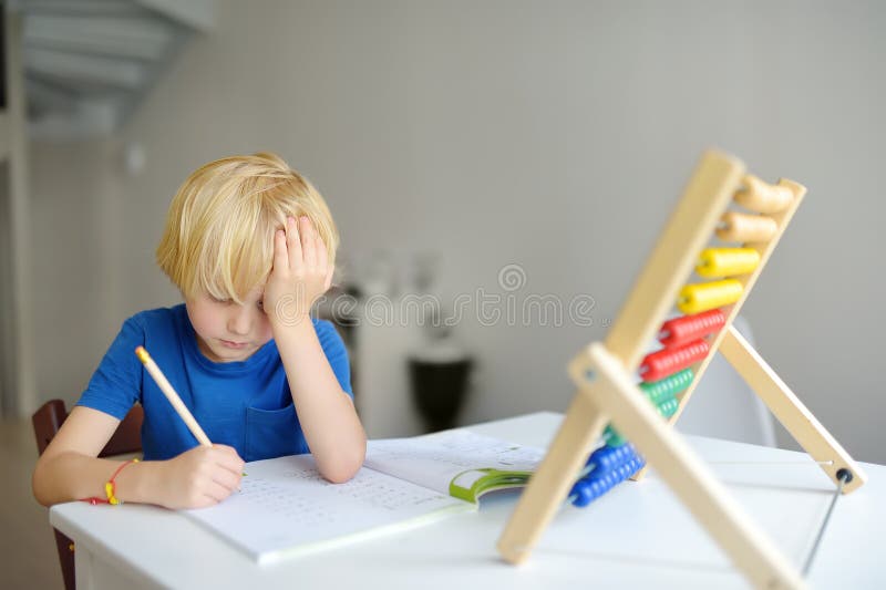 Elementary Student Boy Doing Homework at Home. Child Learning To Count ...