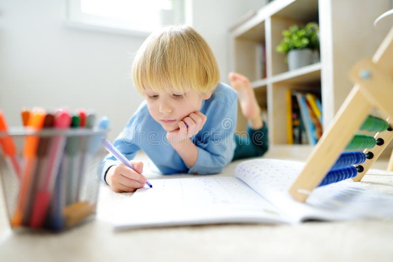 Elementary Student Boy Doing Homework at Home. Child Learning To Count ...