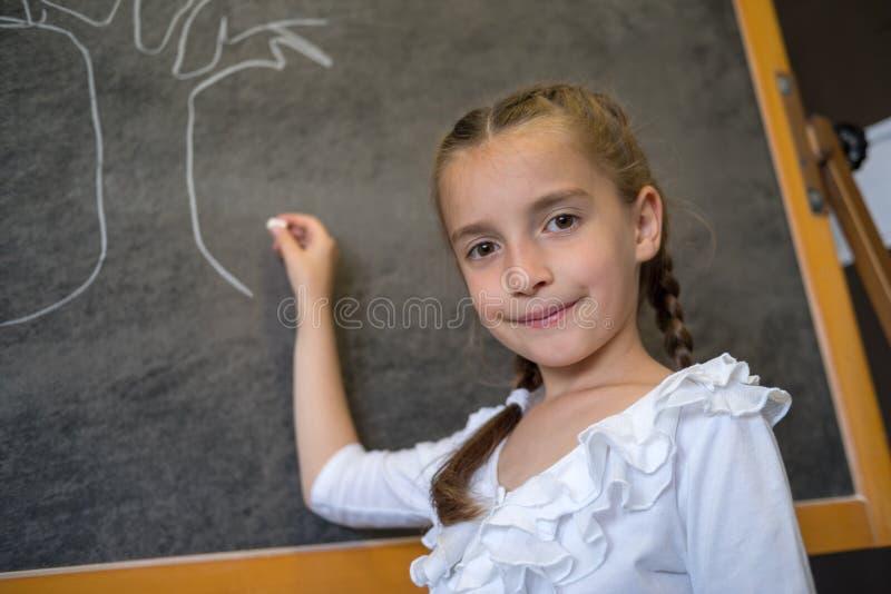 Elementary Student Drawing on Blackboard Stock Photo - Image of ...