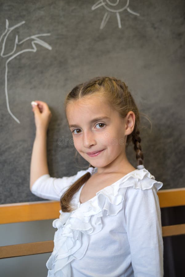 Elementary Student Drawing on Blackboard Stock Image - Image of ...