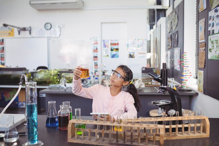 Elementary Student Examining Liquid in Beaker Stock Image - Image of ...