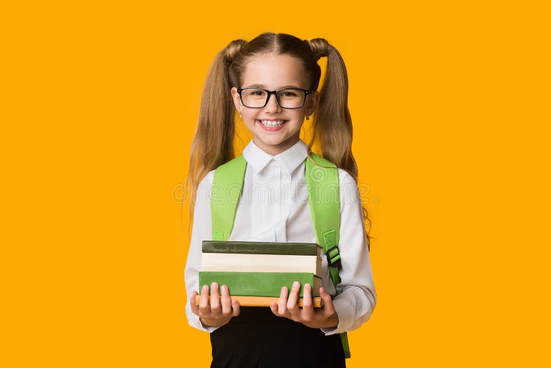 Elementary Student Girl Holding Stack of Books Over Yellow Background ...
