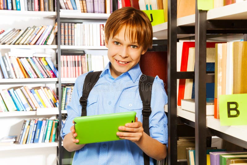 Elementary Student with Tablet in Library Stock Photo - Image of happy ...
