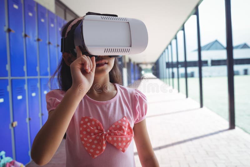 Elementary Student Using Virtual Reality Glasses in Corridor Stock ...