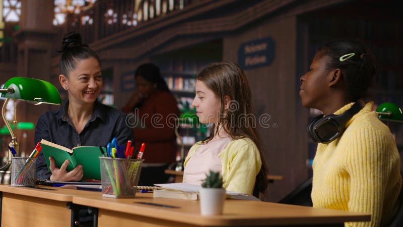 Elementary Students Receiving Support from a Tutor Working on Homework ...