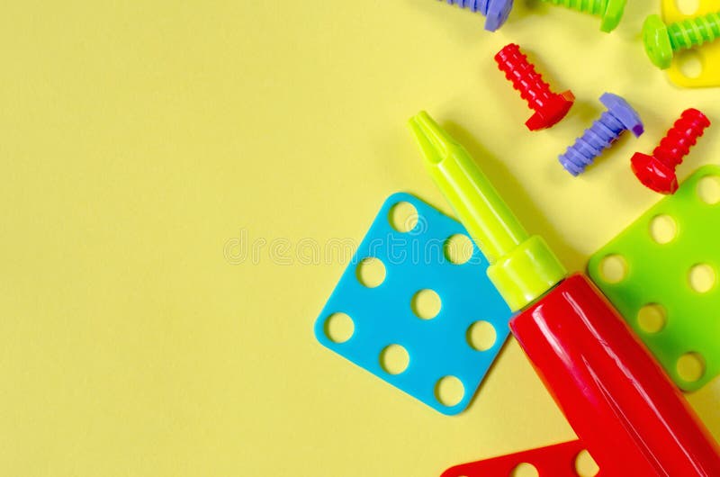 Elements of Children`s Multi-colored Constructor on a Yellow Background ...