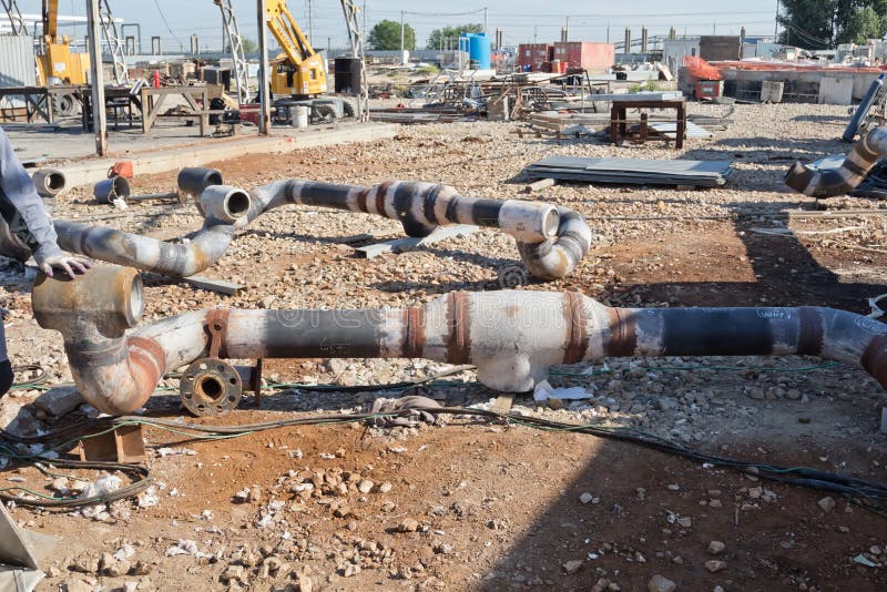 Elements of the Pipeline are at a Construction Site on the Background ...