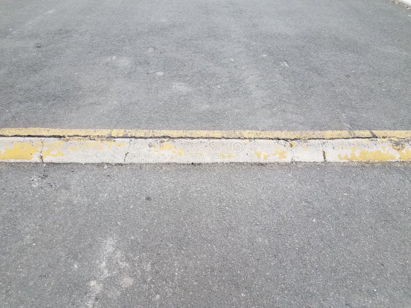 Elevated Asphalt or Pavement Path with Yellow Curb or Ramp Stock Photo ...