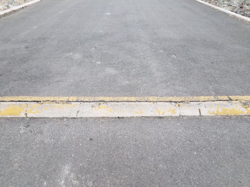 Elevated Asphalt or Pavement Path with Yellow Curb or Ramp Stock Photo ...