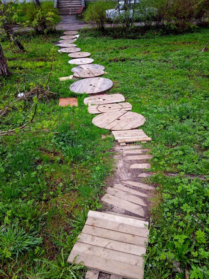An Elevated Wooden Path Curves through a Green Lawn Stock Image - Image ...