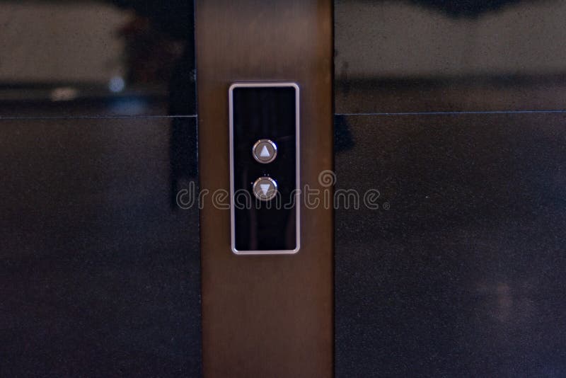 Elevator Call Buttons on a Brown Wooden Panel Stock Image - Image of ...