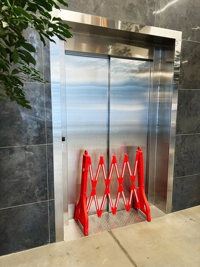 Elevator Doors Blocked by Red Safety Barrier in a Modern Building Stock ...
