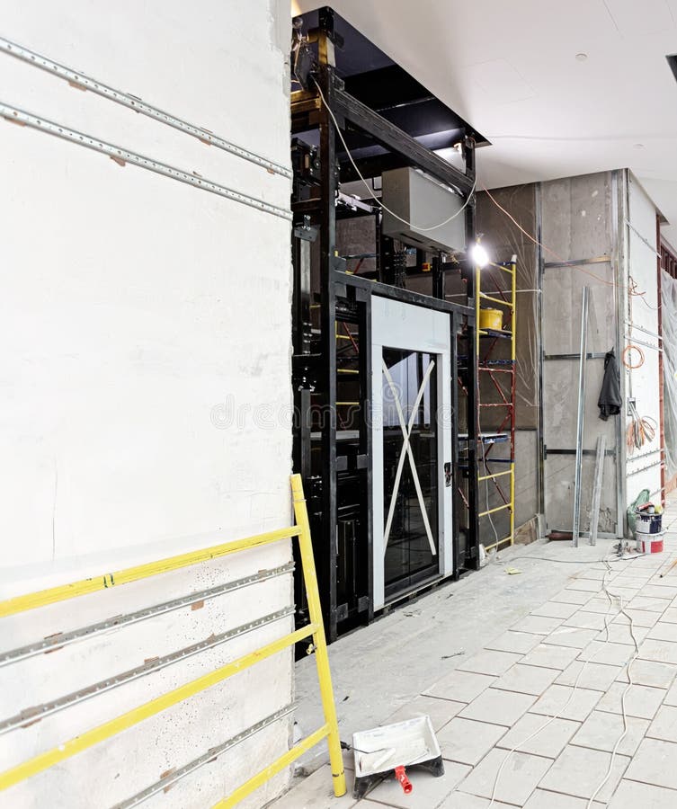 Elevator Installation, Lift Technician Installing a Modern Elevator ...