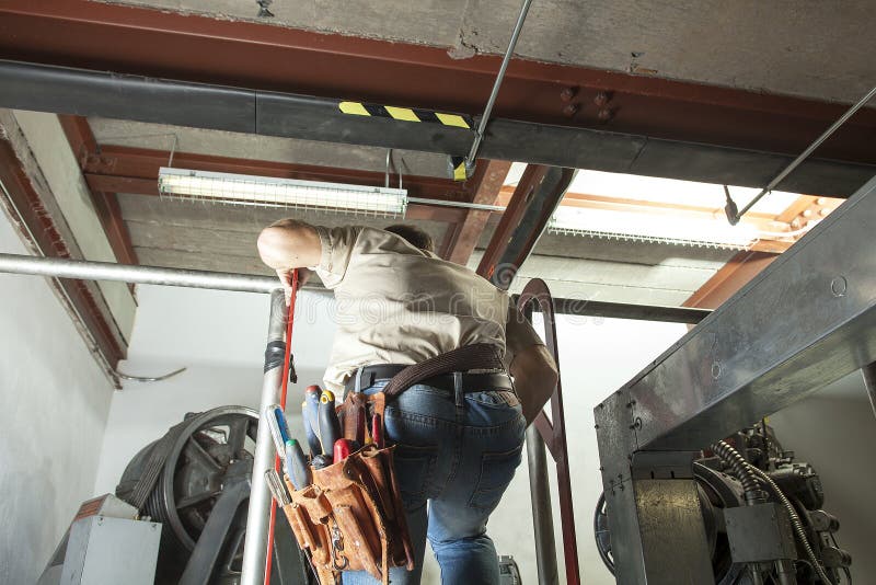Elevator Repair Man at Work Stock Photo - Image of industrial, mechanic ...