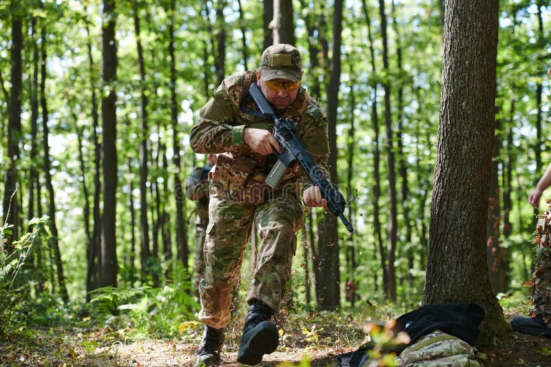 An Elite Soldier, Camouflaged and Stealthily Navigating through ... An Elite Soldier, Camouflaged and Stealthily Navigating through ...