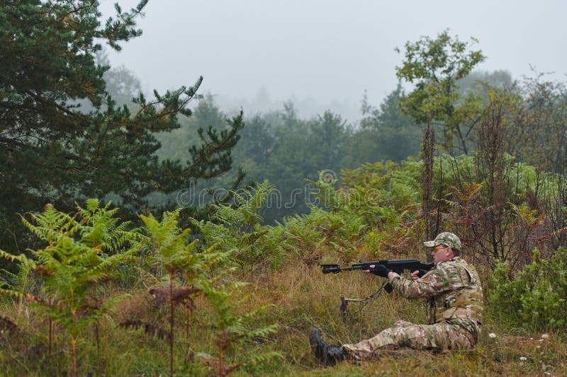 An Elite Soldier, Camouflaged and Stealthily Navigating through ... An Elite Soldier, Camouflaged and Stealthily Navigating through ...