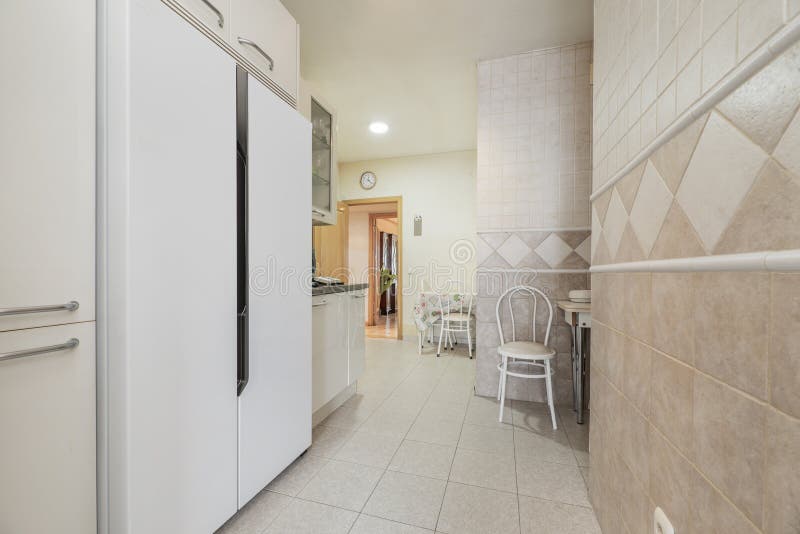 Elongated Kitchen with Black Marble Countertop on White Furniture with ...