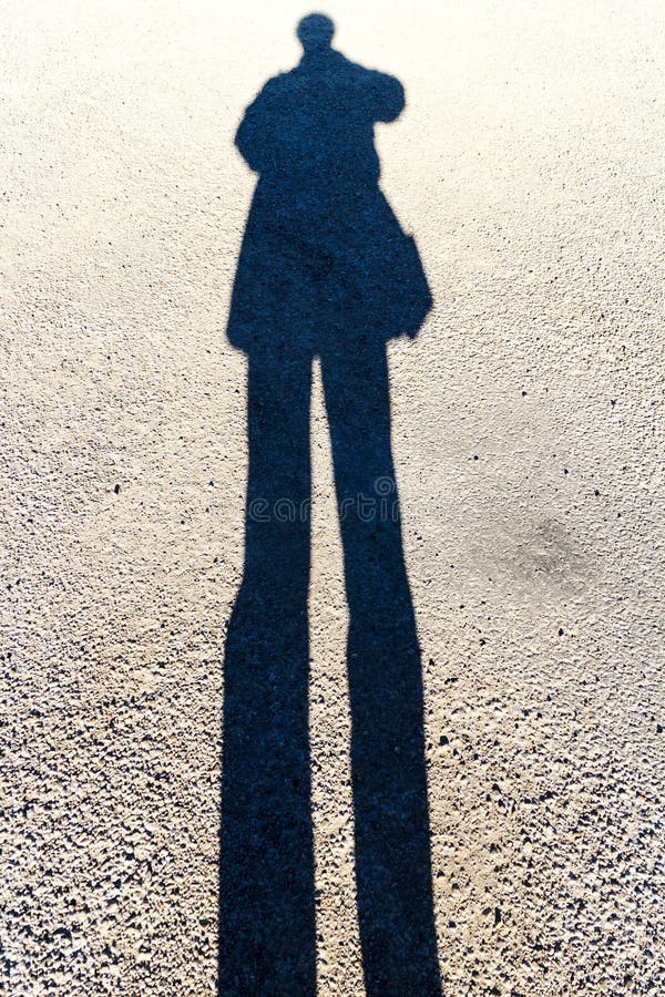 Elongated Shadow of a Person Standing on the Road Stock Photo - Image ...