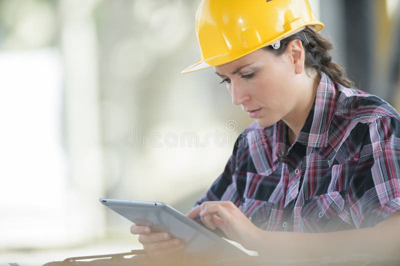 Emale Construction Worker Reading Something on Tablet Computer Stock ...