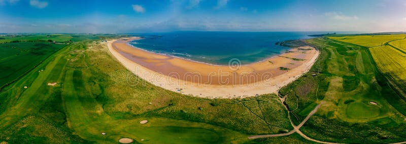 Embleton Bay and Burn Sandy Beach with the Ruins of Dunstanburgh Castle ...