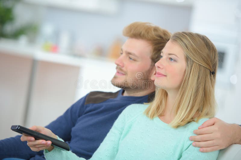 Embracing Couple Using Remote Control Stock Image - Image of happy ...