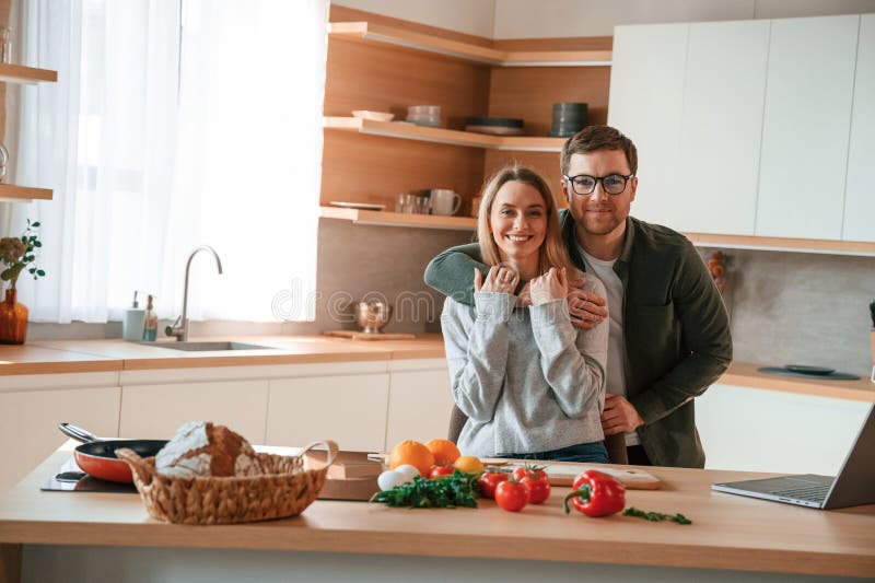 Embracing Each Other. Young Couple is on the Kitchen Together Stock ...