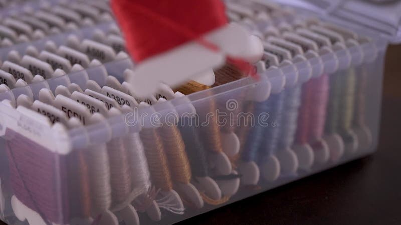 Embroidery Essentials: Hand Selecting a Red Floss from a Bobbin Box ...