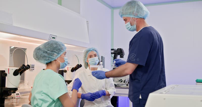 Embryologists Performing Artificial Fertilization in Laboratory Setting ...