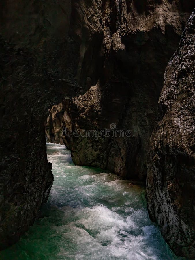 Emerald Green Water Flows through a Mountain Gorge in Complete Darkness ...