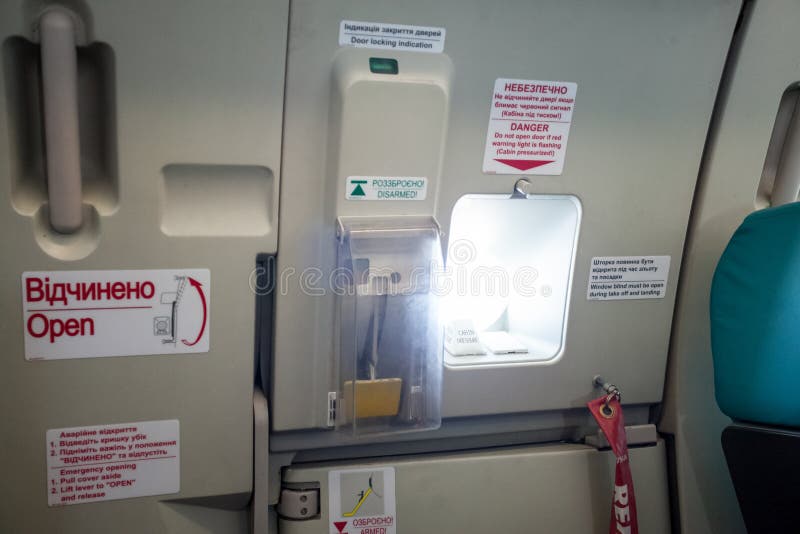 Emergency Exit Door with Porthole in Airplane Stock Photo - Image of ...