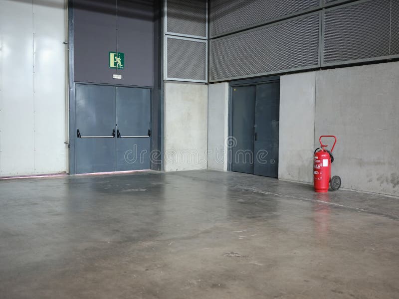 Emergency Exit Doors of an Industrial Area with a Fire Extinguisher ...
