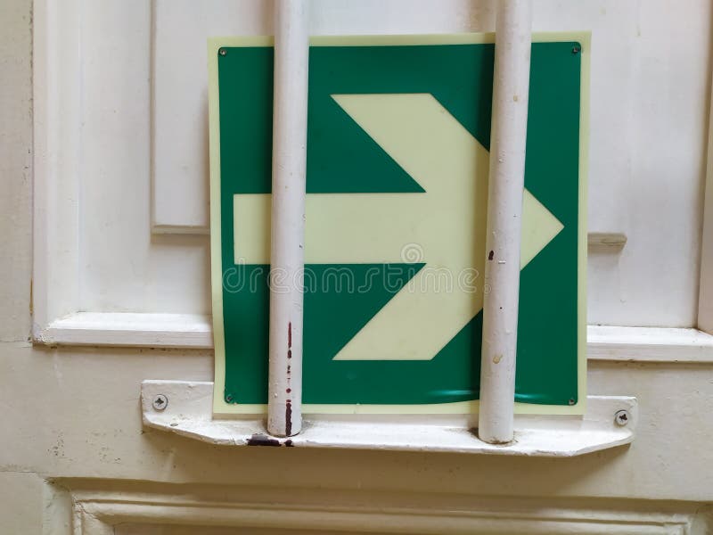 Emergency Exit with Green Arrow, Handle and Lock on Old House Door ...