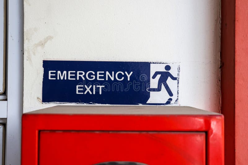 An Emergency Exit Sign Affixed To a White Wall Stock Photo - Image of ...