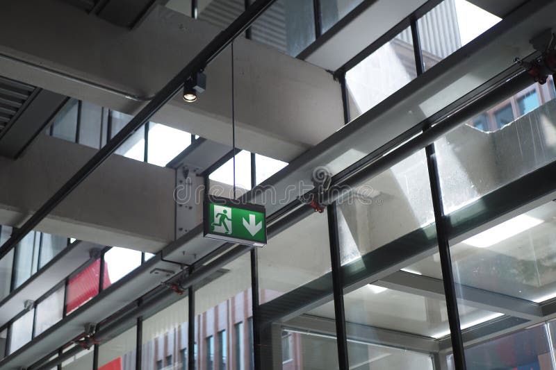 Emergency Exit Sign Illuminated in a Modern Glass Building Stock Image ...