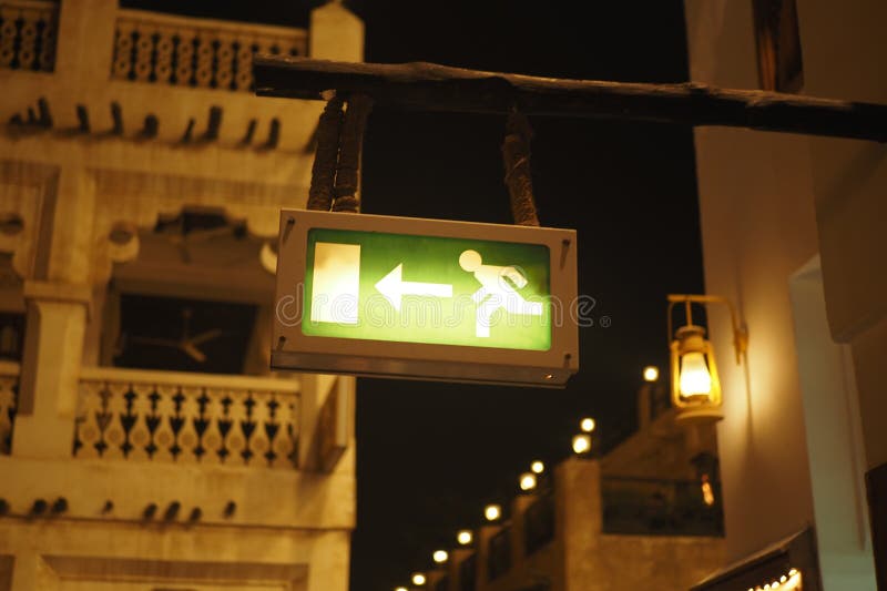 Emergency Exit Sign Illuminated at Night in a Historic Area Stock Image ...
