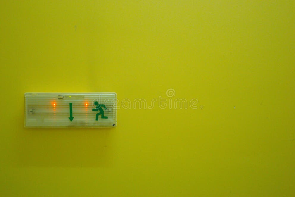 Emergency Exit on the Yellow Wall Stock Photo - Image of message, green ...