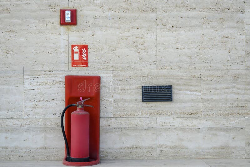 Emergency Fire Extinguisher Standing on the Wall Stock Photo - Image of ...