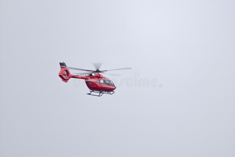 An Emergency Red Helicopter Flying on the Sky on a Cloudy Day Editorial ...